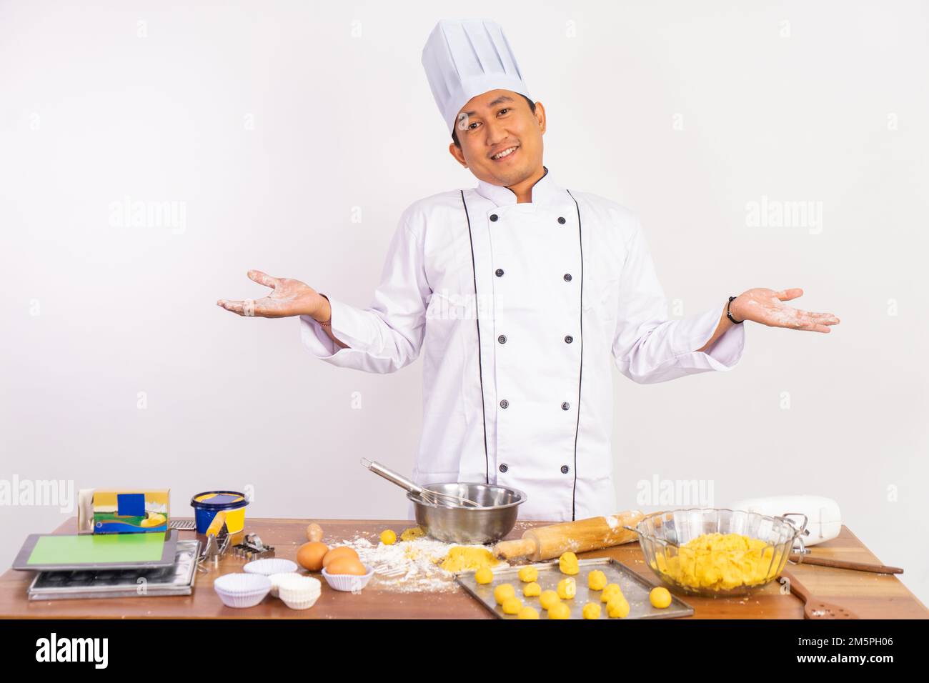 male chef with a questioning gesture behind the kitchen counter Stock ...