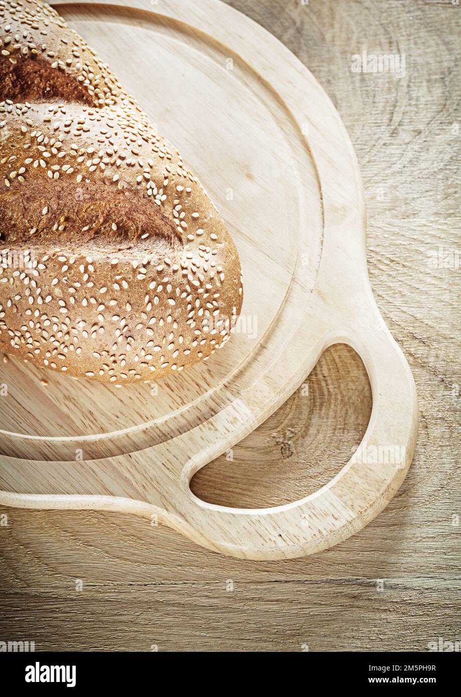 Bread carving board on wooden background Stock Photo - Alamy