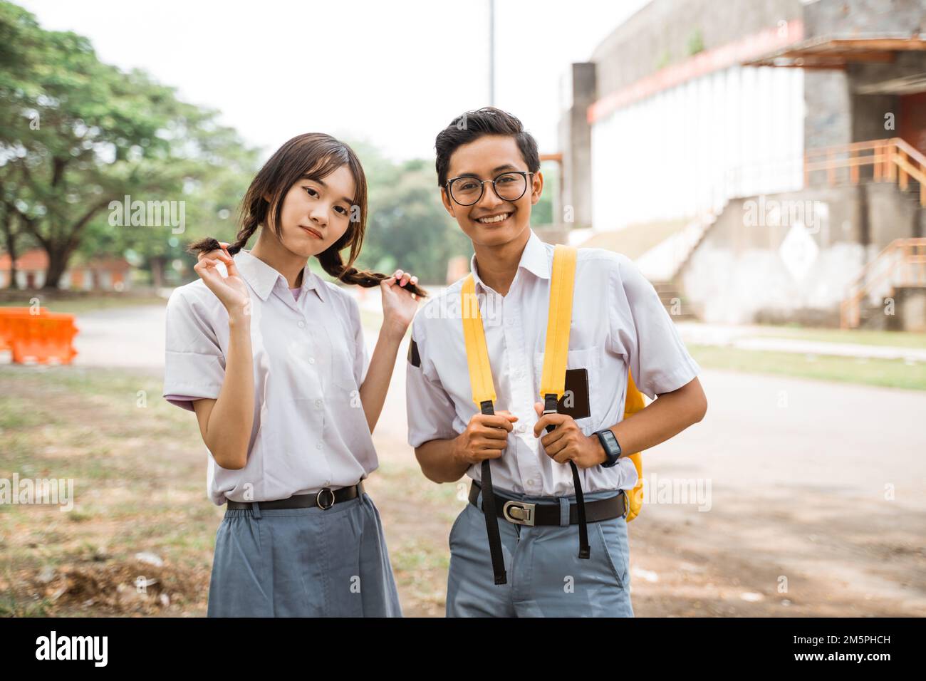 Geeky boy student in glasses smiling with girl friends Stock Photo - Alamy