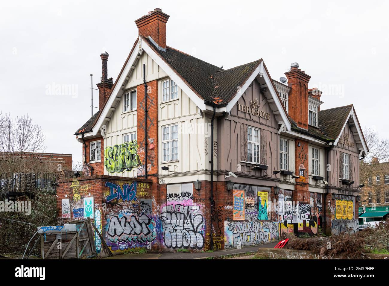 The closed down and vandalised Grove pub which is cover with fly ...