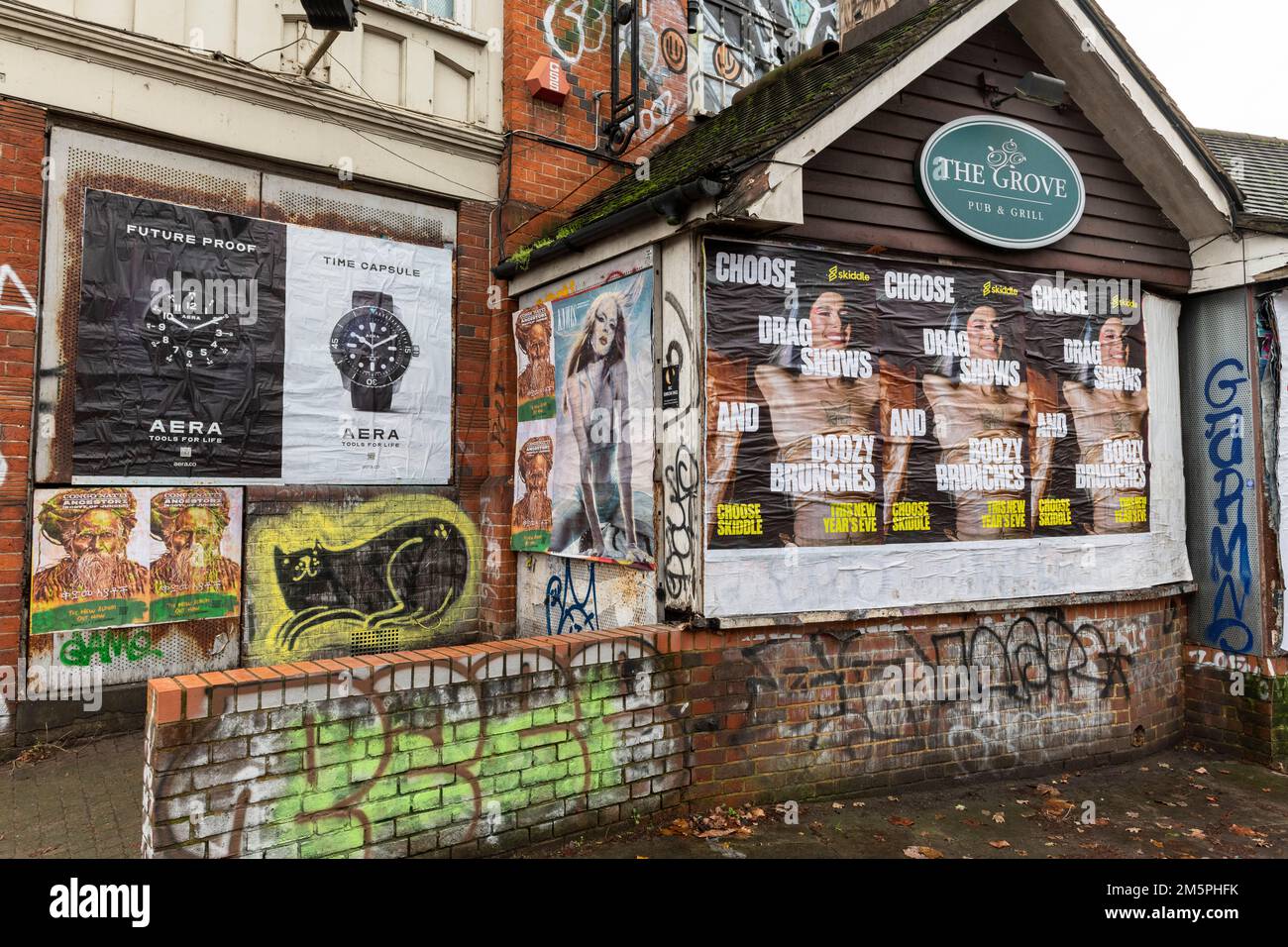 The closed down and vandalised Grove pub which is cover with fly ...
