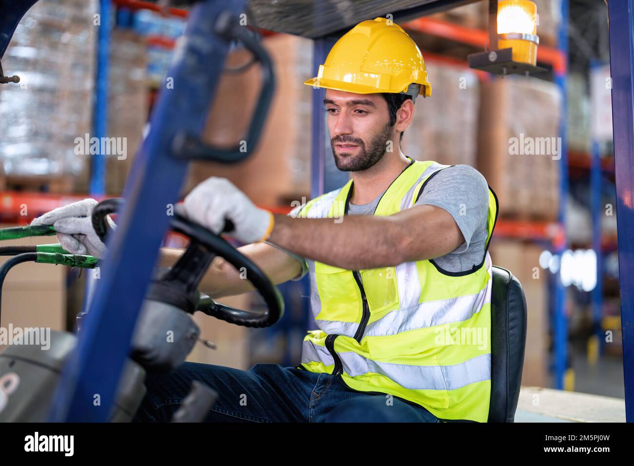 Forklift Truck Operator Lifts Pallet Cardboard Boxes On a Shelf by ...
