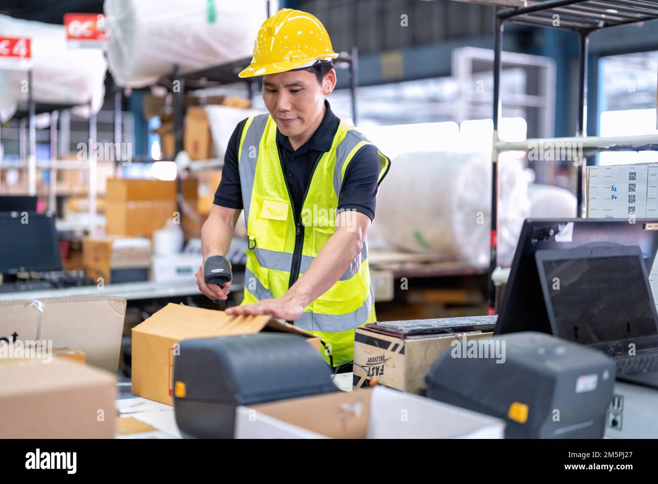 Worker working in the large depot storage warehouse happy smiling ...