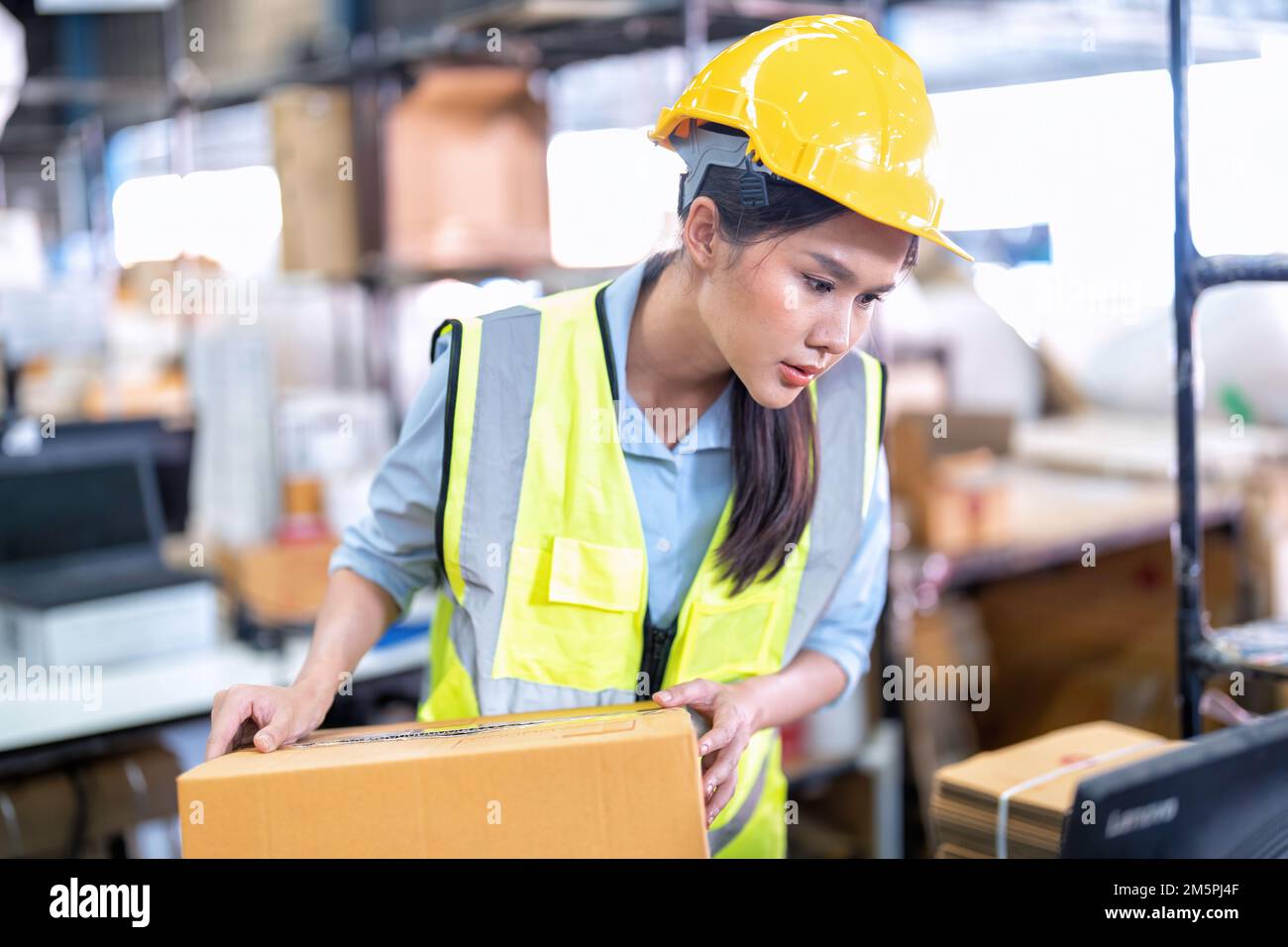 Worker working in the large depot storage warehouse happy smiling ...