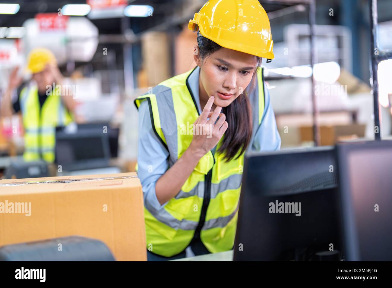 Worker working in the large depot storage warehouse happy smiling ...