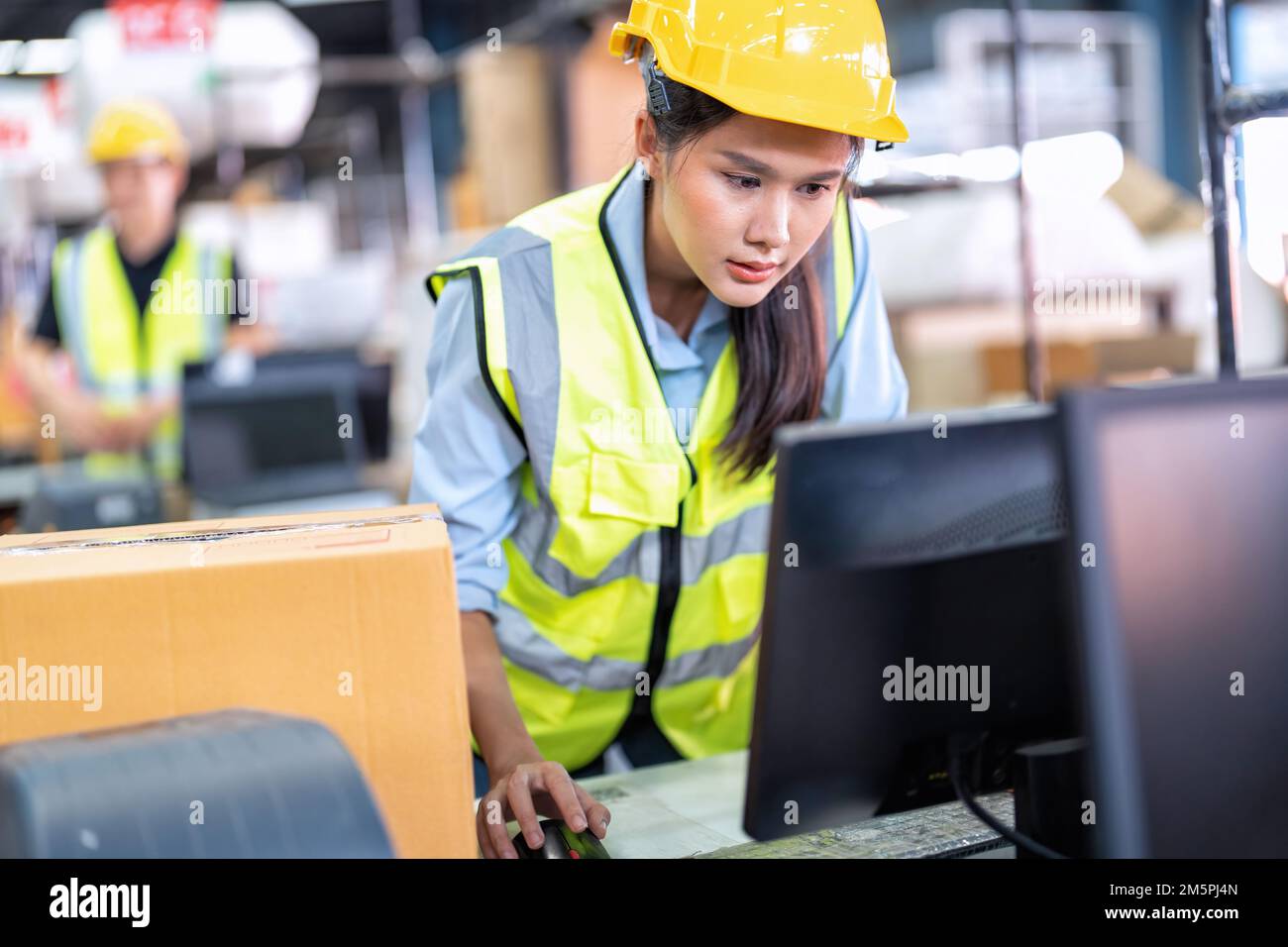 Worker working in the large depot storage warehouse happy smiling ...