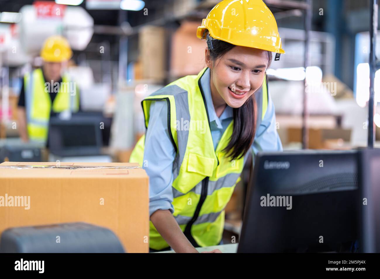 Worker working in the large depot storage warehouse happy smiling ...