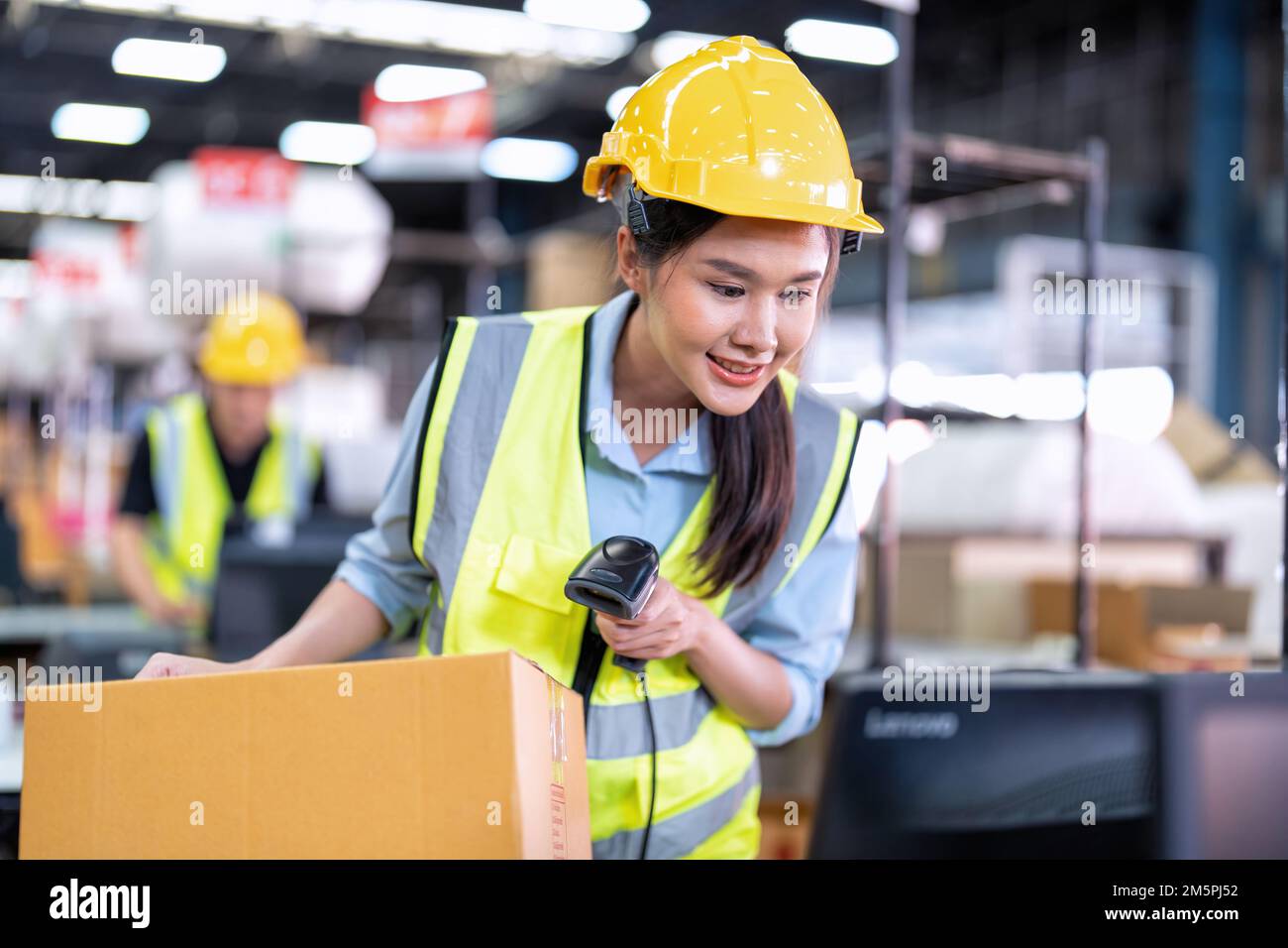 Worker working in the large depot storage warehouse happy smiling ...
