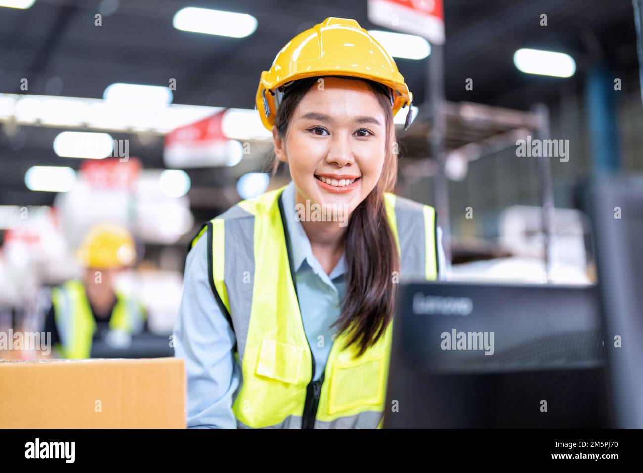 Worker working in the large depot storage warehouse happy smiling ...