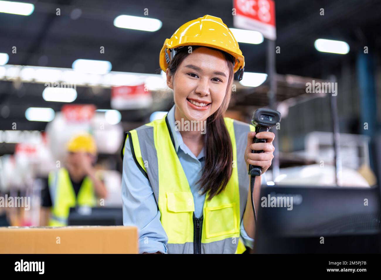Worker working in the large depot storage warehouse happy smiling ...