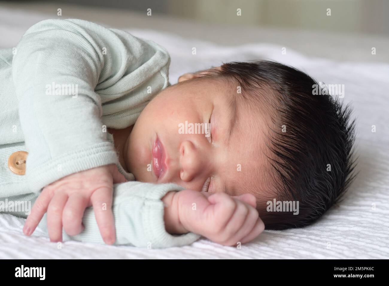 Newborn girl lots hair sleeping hi-res stock photography and images - Alamy