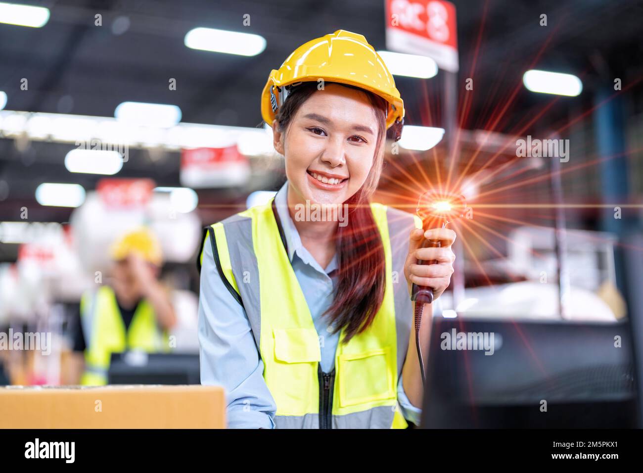 Worker in large depot storage warehouse hold scanner in hand show red ...