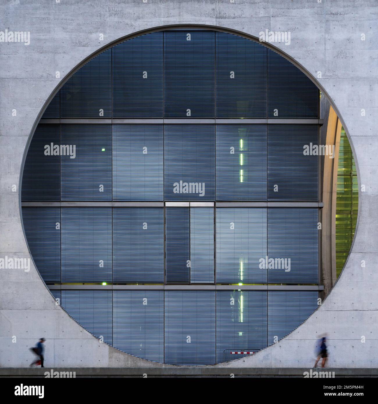 Symmetrical circular shaped window in a rectangle building with moving ...