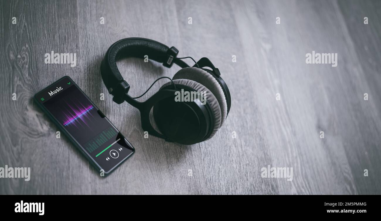 Smartphone playing music with headphones. Wooden background. Radio ...