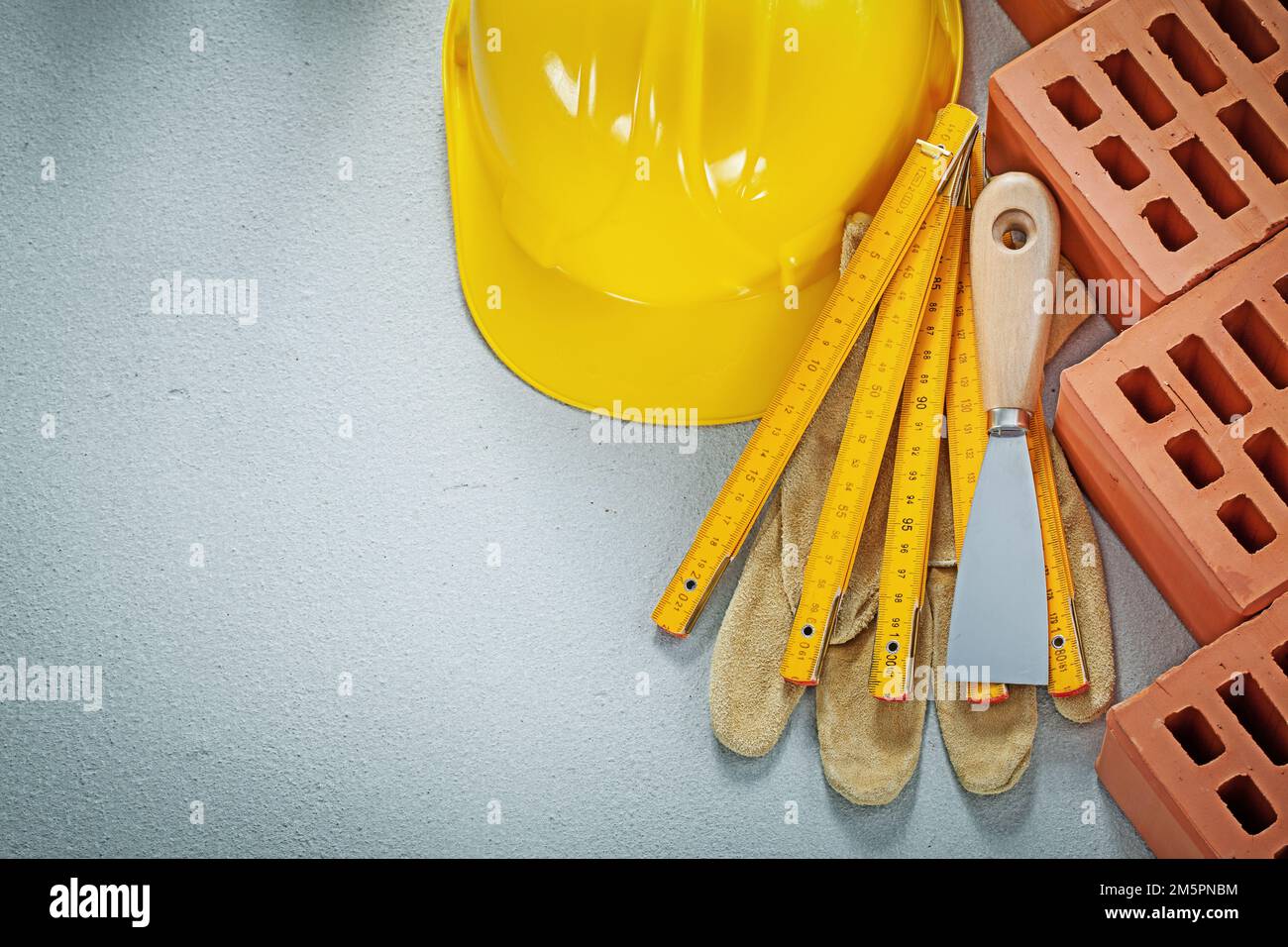 Composition of bricklaying tools on concrete background construction ...