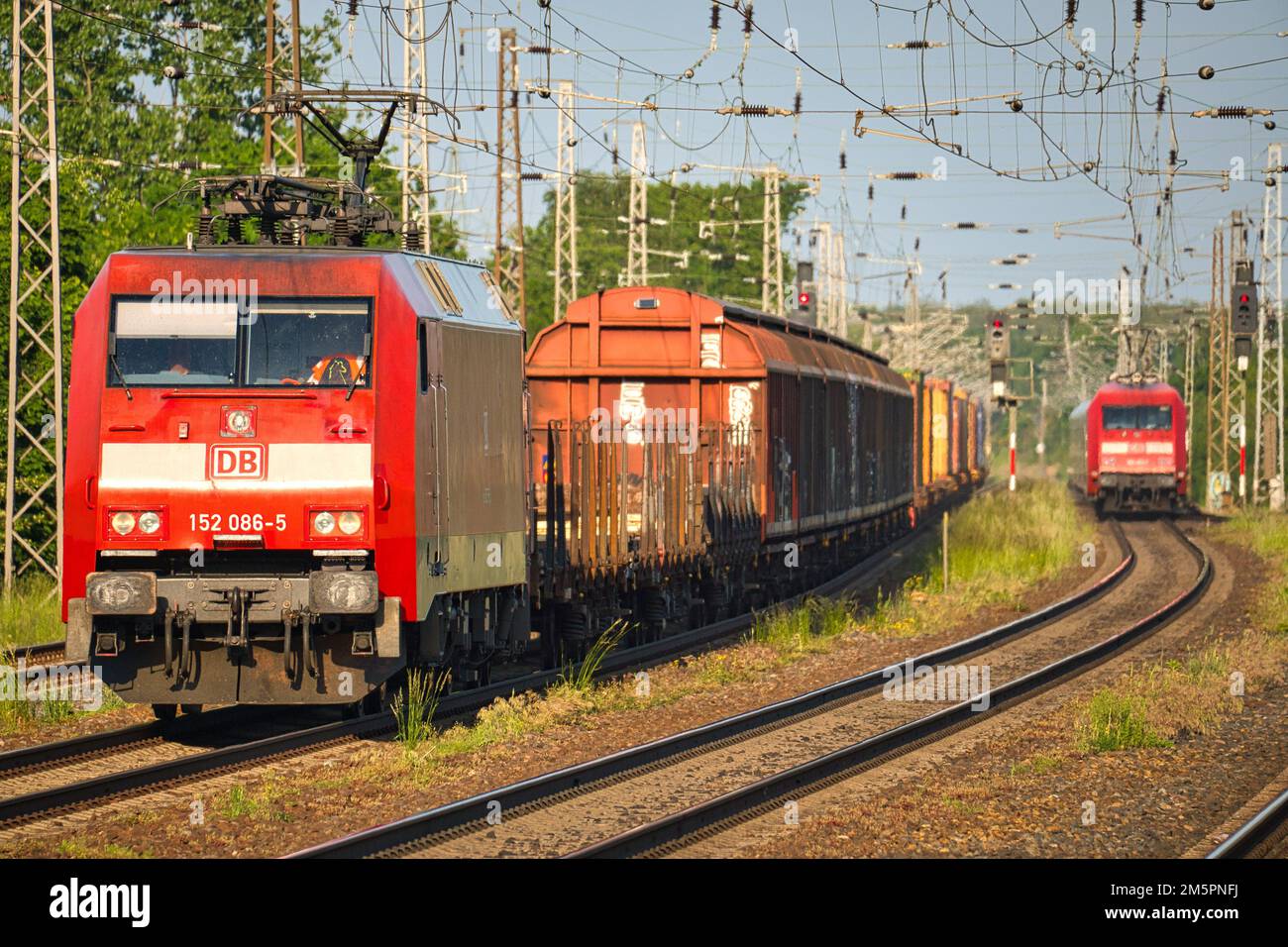 A cargo class locomotive with colorful wagons passing through Saarmund ...