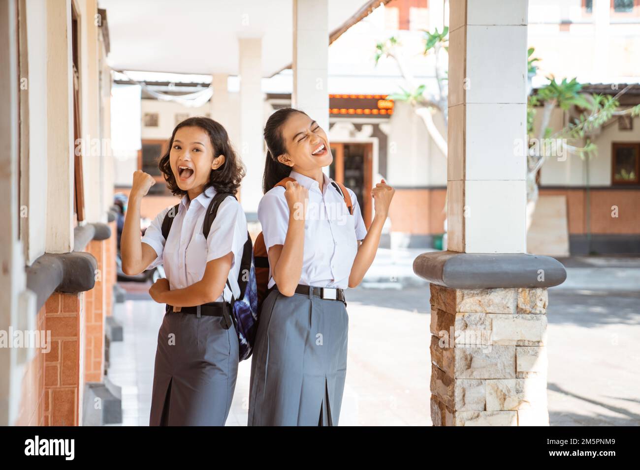 Two high school teenage girls excited while celebrating graduation ...