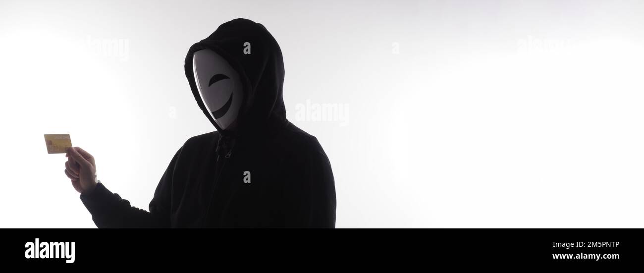Hacker man and credit cards in hand. Represent credit cards personal ...