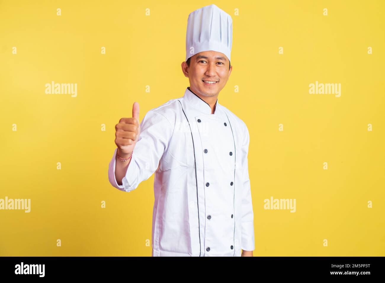 smiling asian male chef with thumbs up on isolated background Stock ...