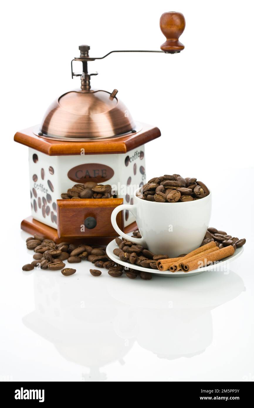 cup and mill with beans isolated Stock Photo - Alamy