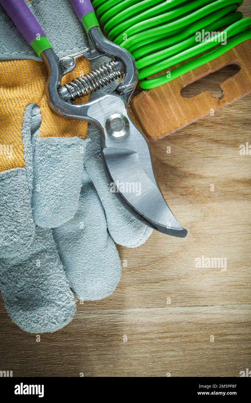 Gardening secateurs garden tie wire protective gloves on wooden board ...