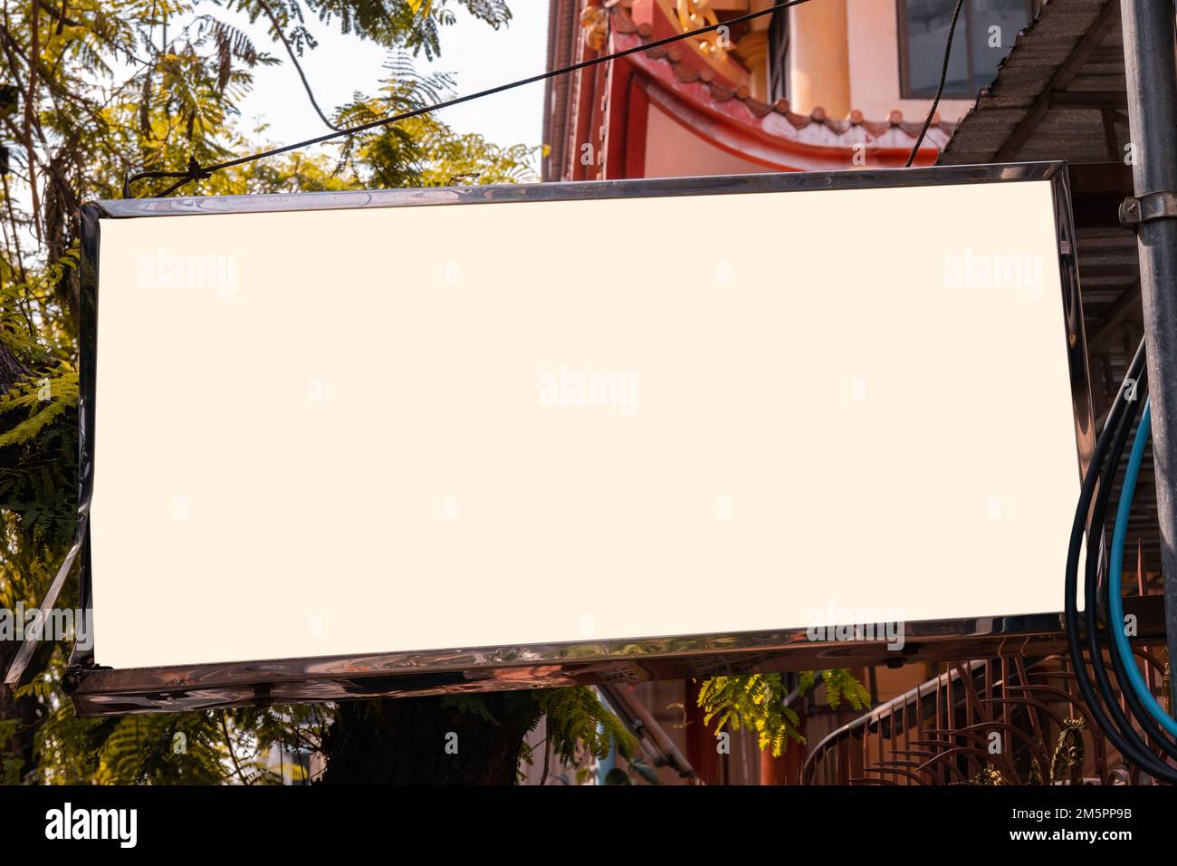 Empty white store sign above the street in Asian city with clipping ...
