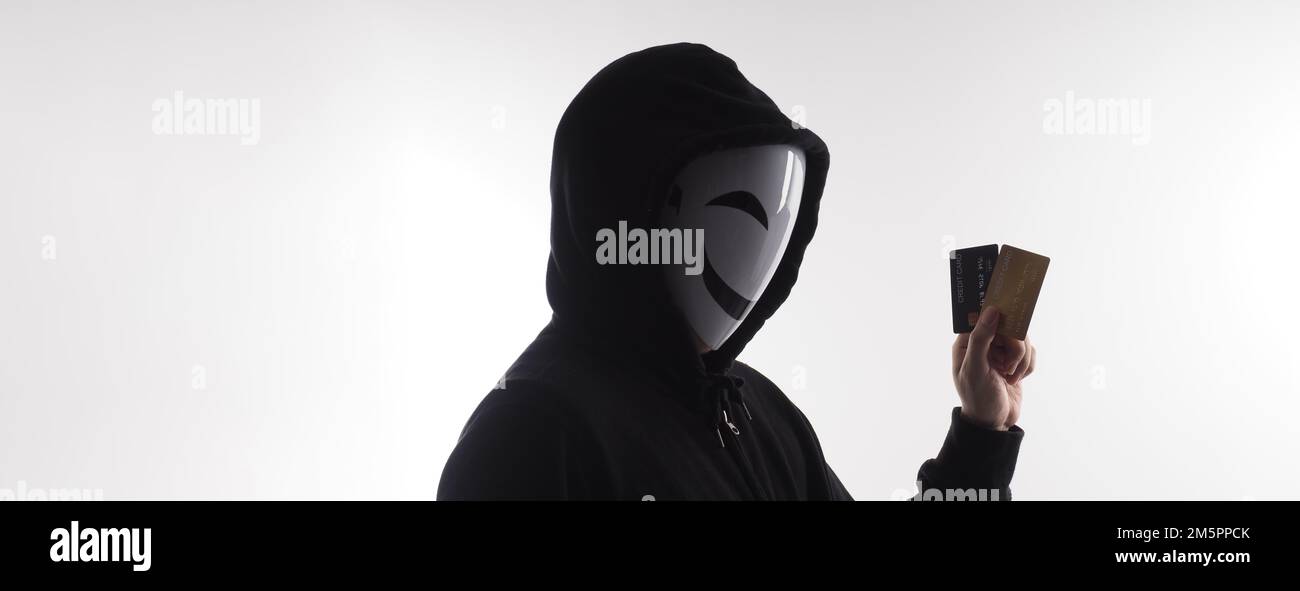 Hacker man and credit cards in hand. Represent credit cards personal ...