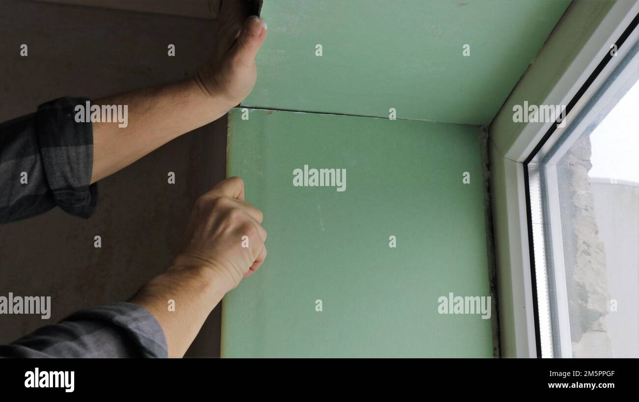 installation of chipboard sheets when making a window opening, a man in ...