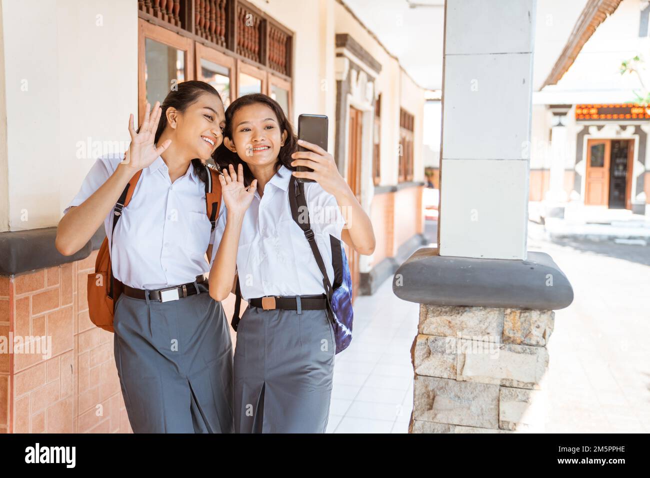 high school asian teen girls using smartphones for video call Stock ...