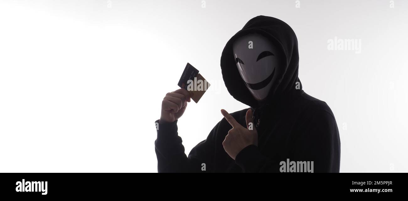 Hacker man and credit cards in hand. Represent credit cards personal ...