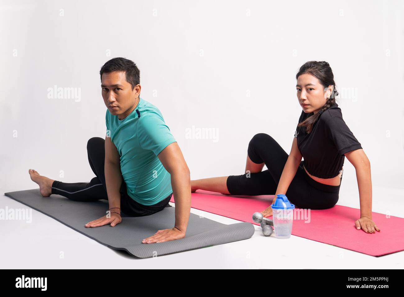 asian couple doing yoga with abdominal stretching movements Stock Photo ...