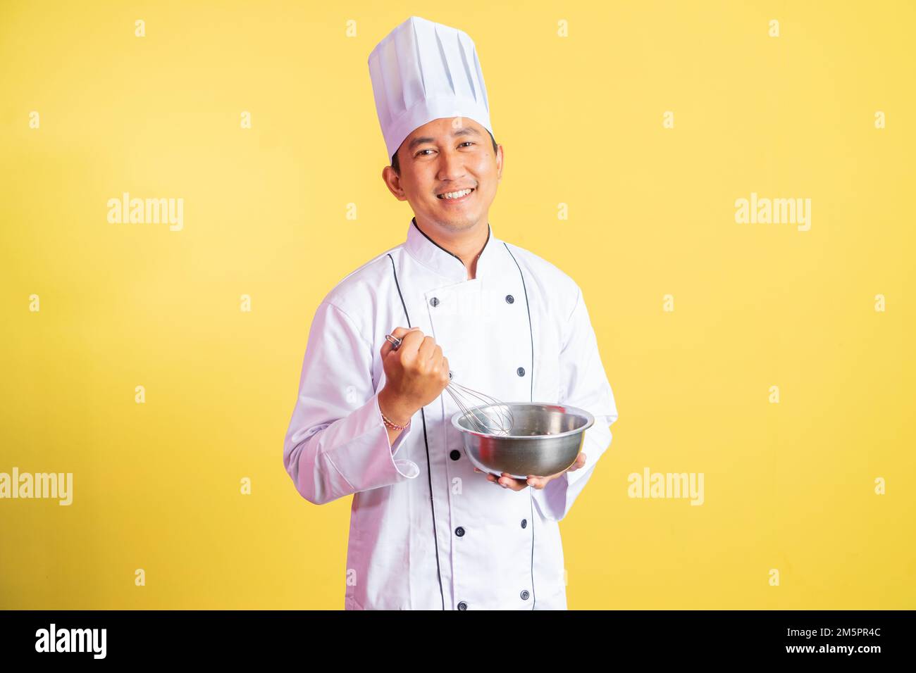 asian male chef smiling while using whisk with mixing bowl Stock Photo ...