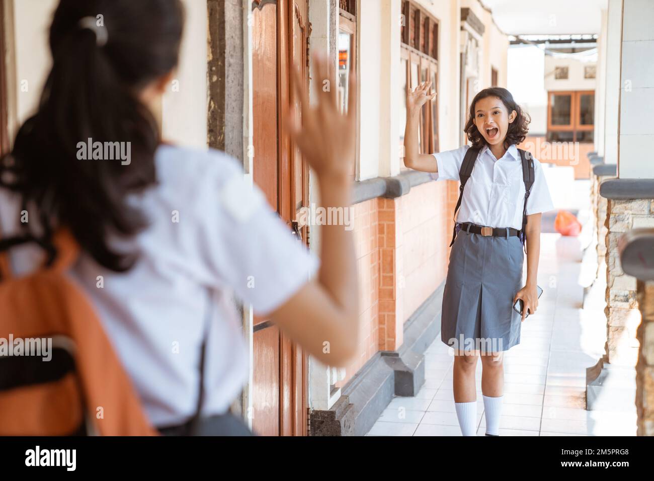 Excited young college student waving hi-res stock photography and ...