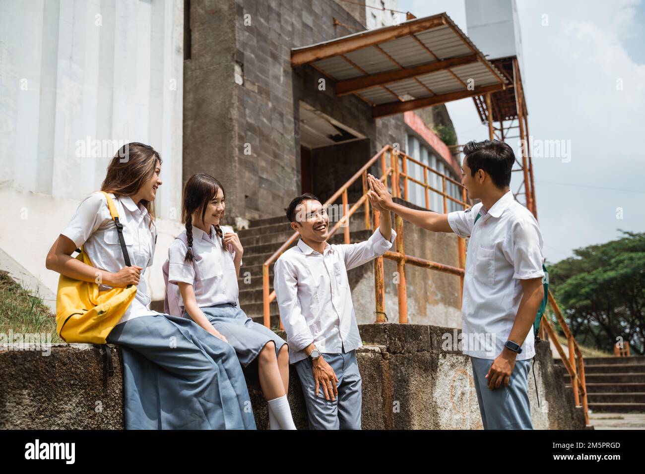 An asian high school student clapping each other when meeting Stock ...