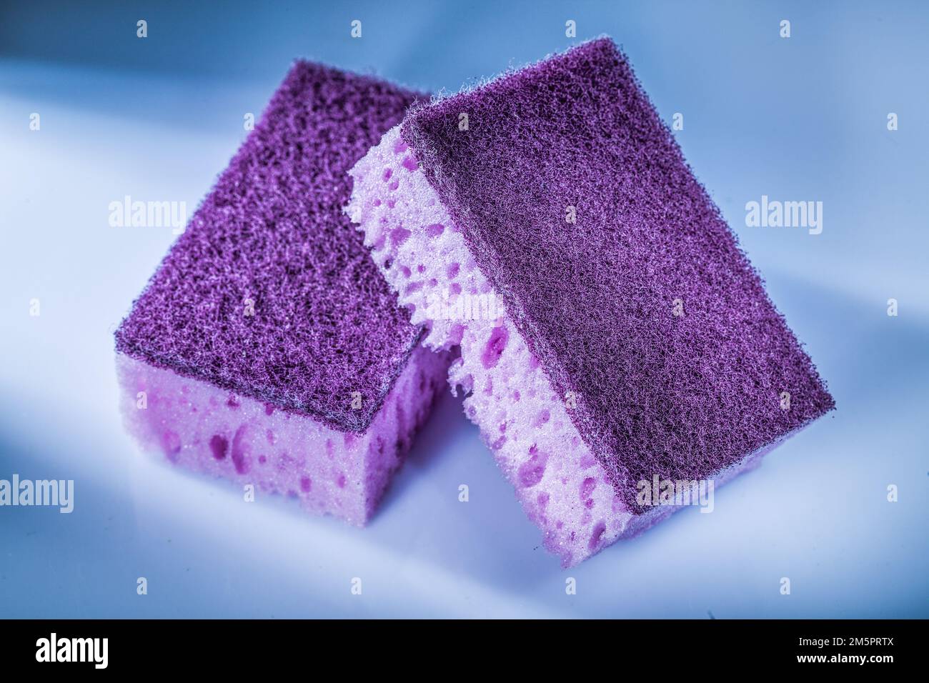New violet kitchen sponges on white surface Stock Photo - Alamy