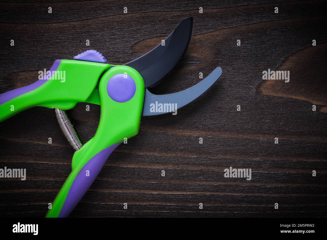 Metal sharp secateurs on vintage wooden background close up version ...