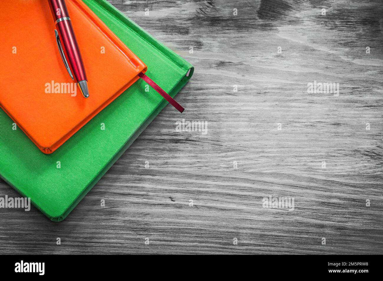 Notepads biro on wooden board office concept Stock Photo - Alamy