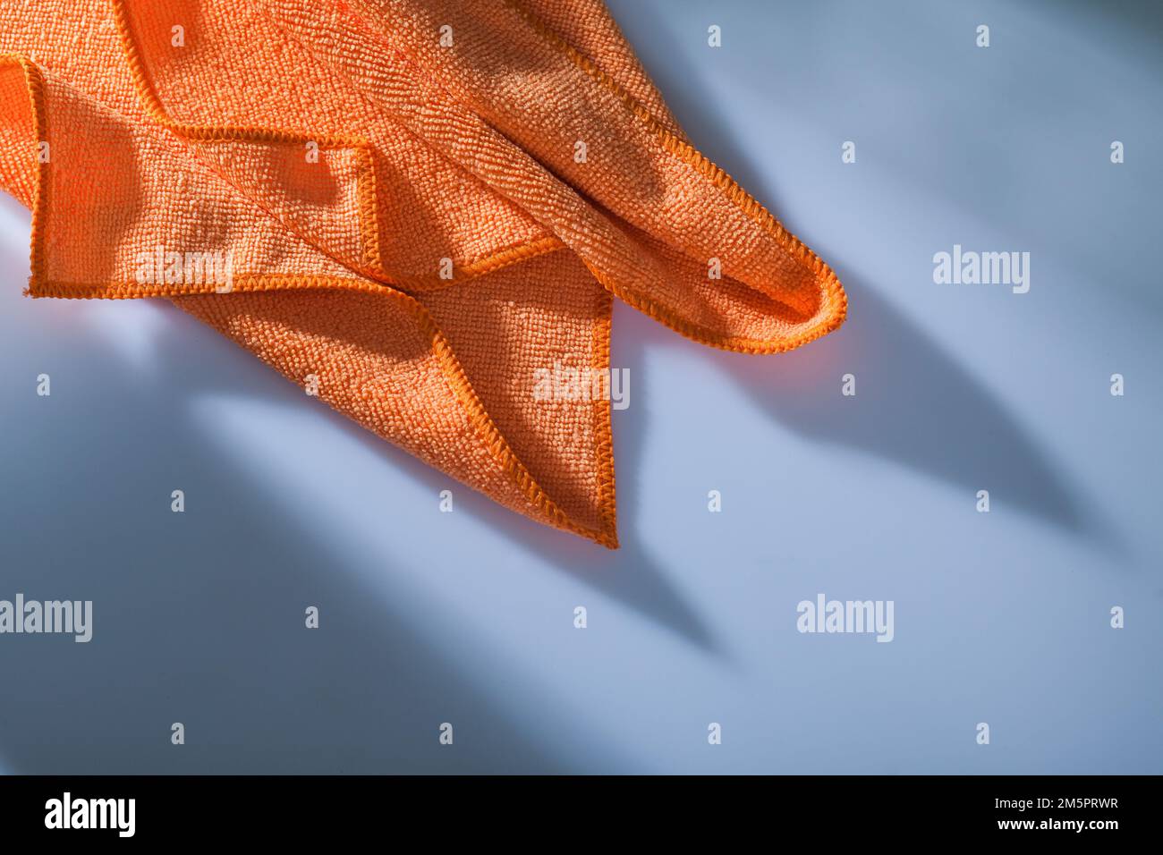 Orange kitchen dishwashing rag on white background Stock Photo - Alamy