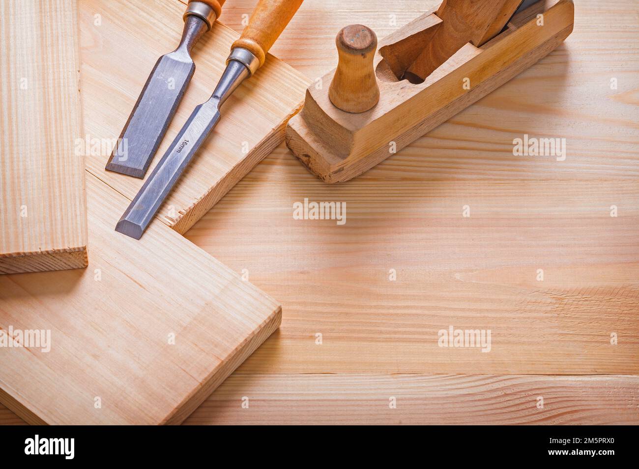 old fashioned woodworkers plane carpentry chisel and wooden planks ...