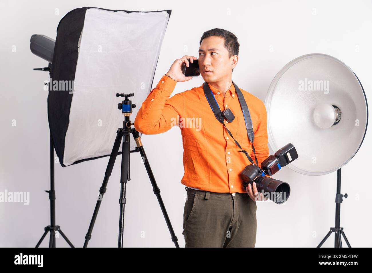 male vlogger making phone call while holding camera Stock Photo - Alamy