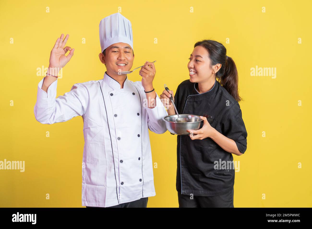 chef tasting food with okay hand gestures with female chef Stock Photo ...