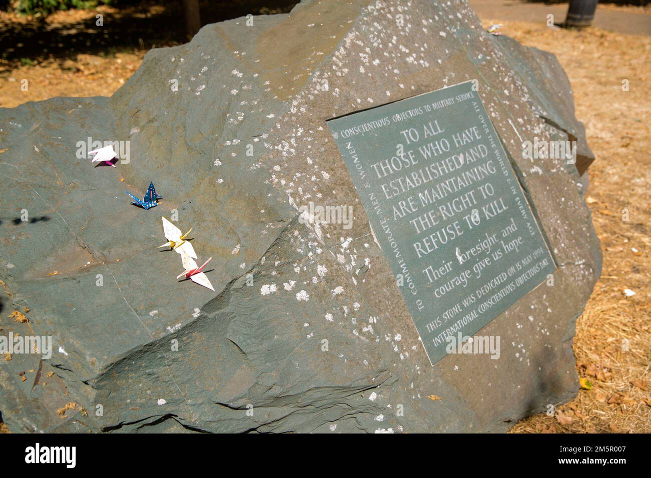 Paper cranes are seen on a memorial as people gather near the cherry ...
