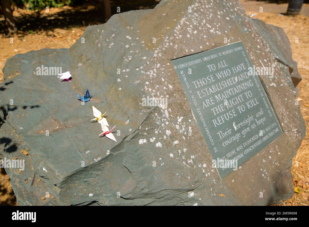 Paper cranes are seen on a memorial as people gather near the cherry ...