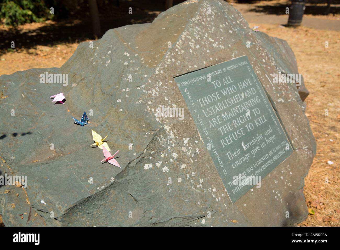 Paper cranes are seen on a memorial as people gather near the cherry ...