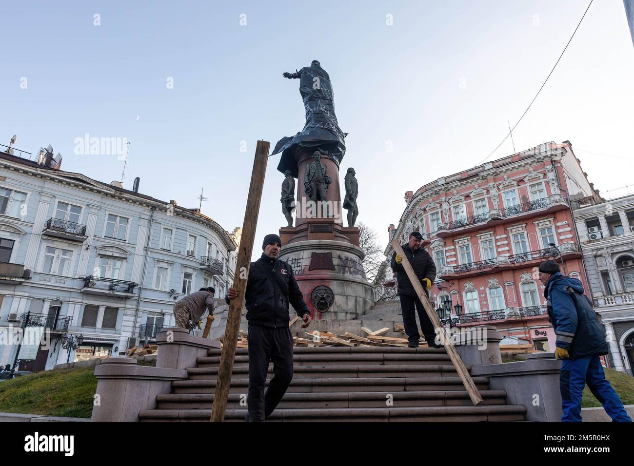 Workers carry away the boards left after dismantling the protective ...