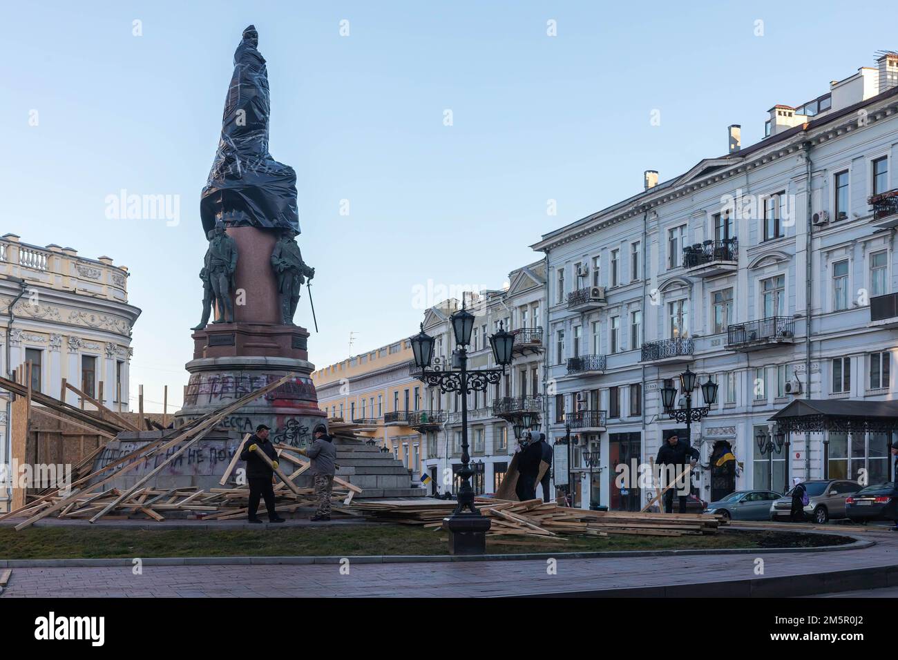 Workers dismantle wooden protective barriers near the monument to the ...