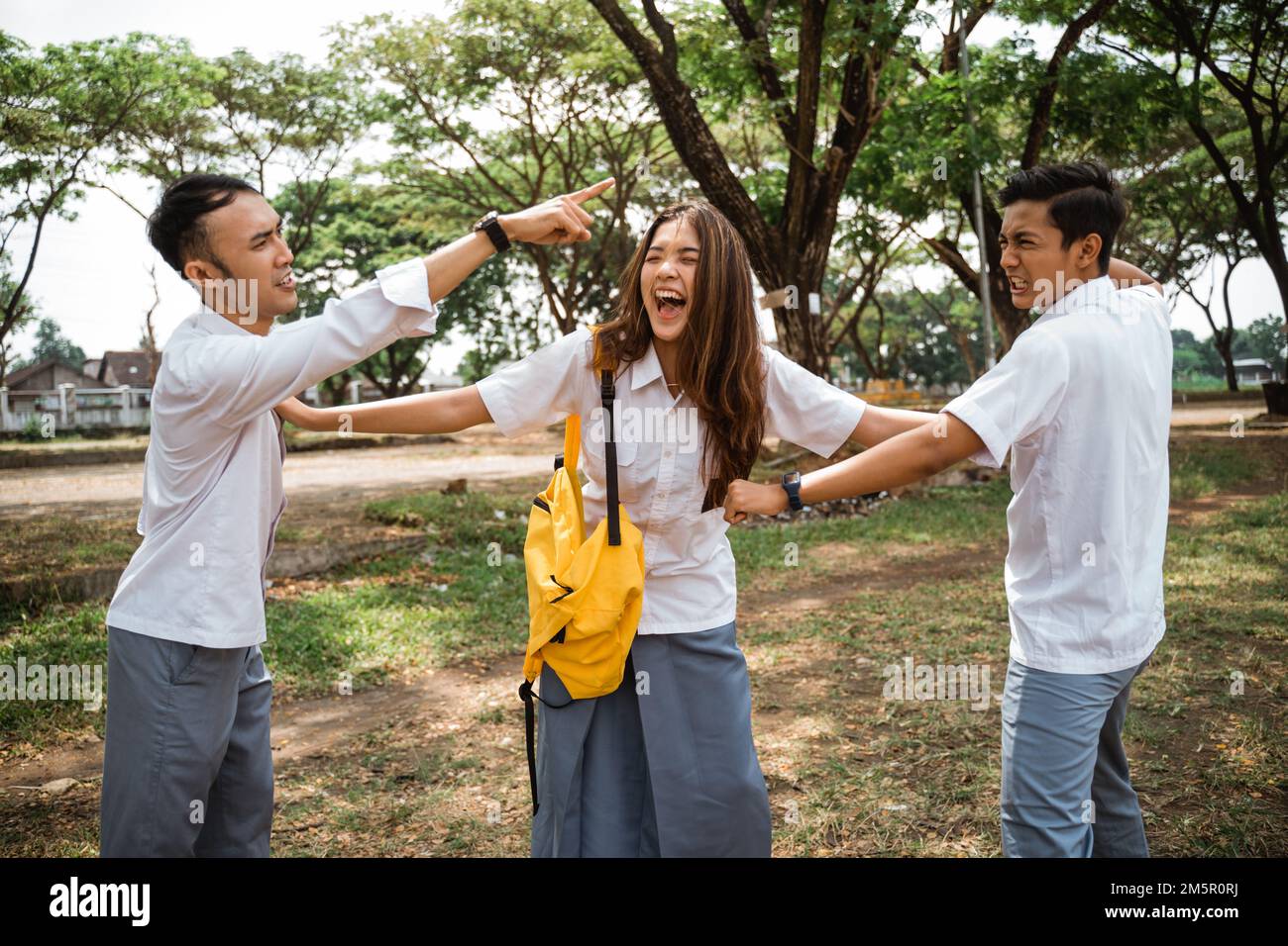 Two male high school students fighting for one girl Stock Photo - Alamy
