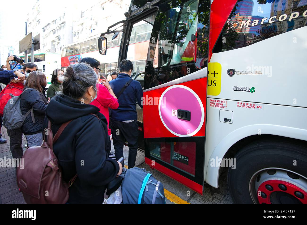 Passengers boarding a coach to Macau from Prince Edward in Hong Kong ...