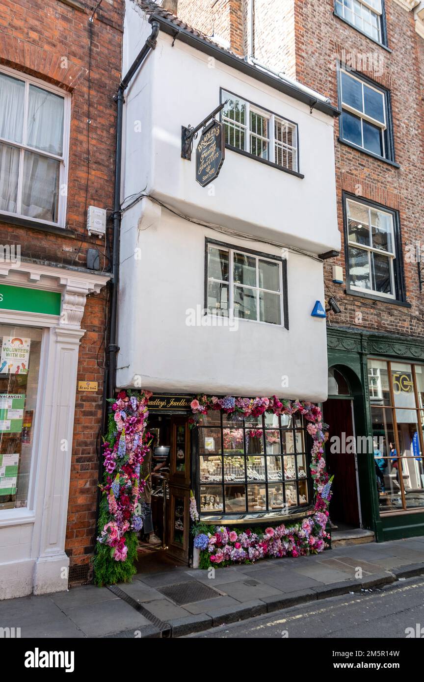 A bay window and door entrance surrounded with an artificial colourful ...