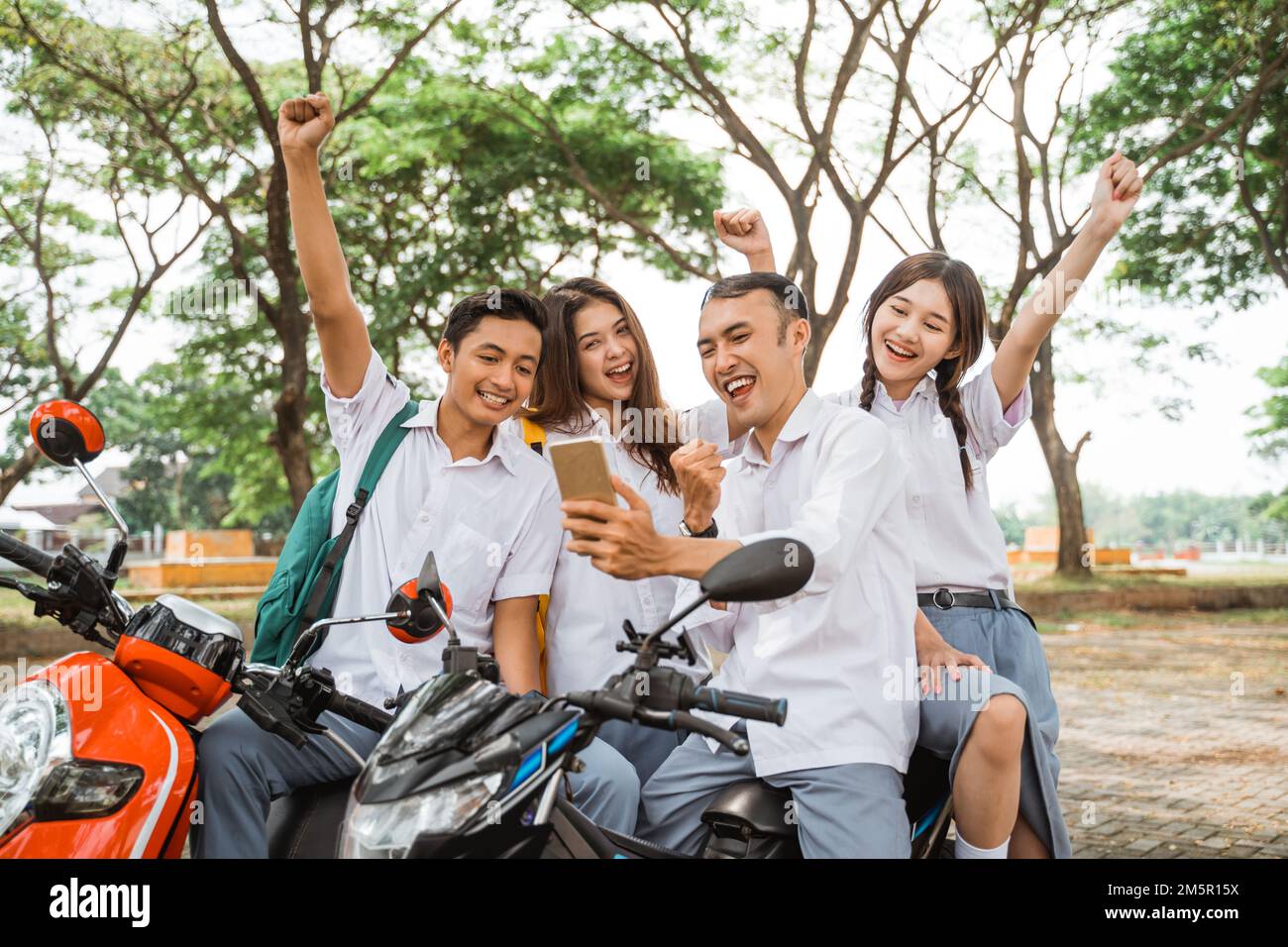 Happy high school student selfie using smartphone celebrating ...
